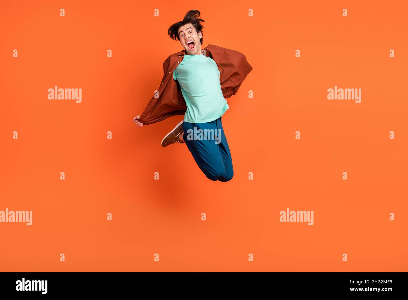 Full size photo of young handsome male jumping screaming fooling around ...
