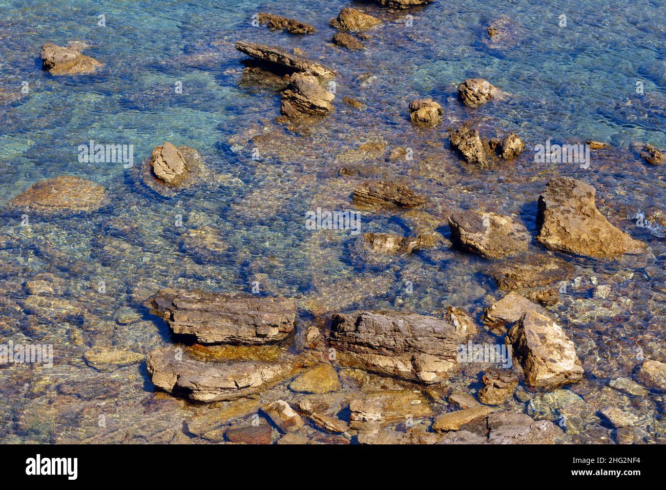 Waves impact coastal rocks . Big stones in transparent tropical water ...