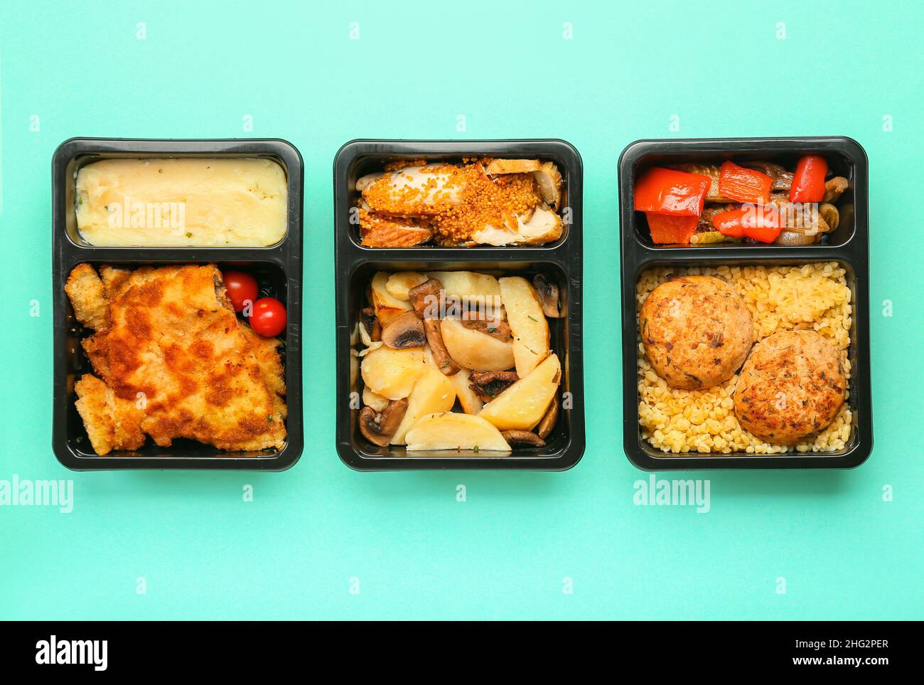 Food delivery containers with meals on color background Stock Photo - Alamy
