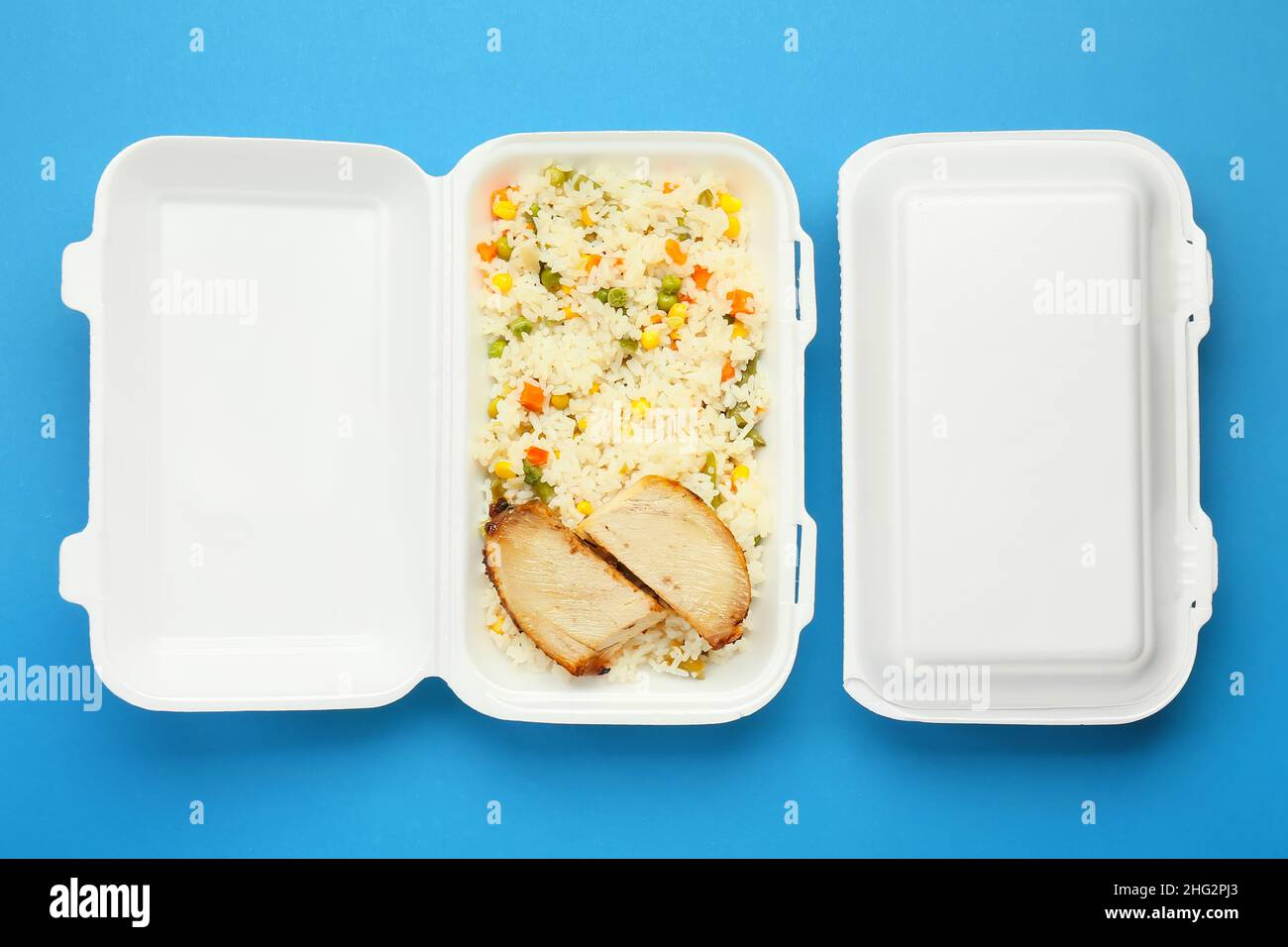 Lunch boxes with food on color background Stock Photo - Alamy