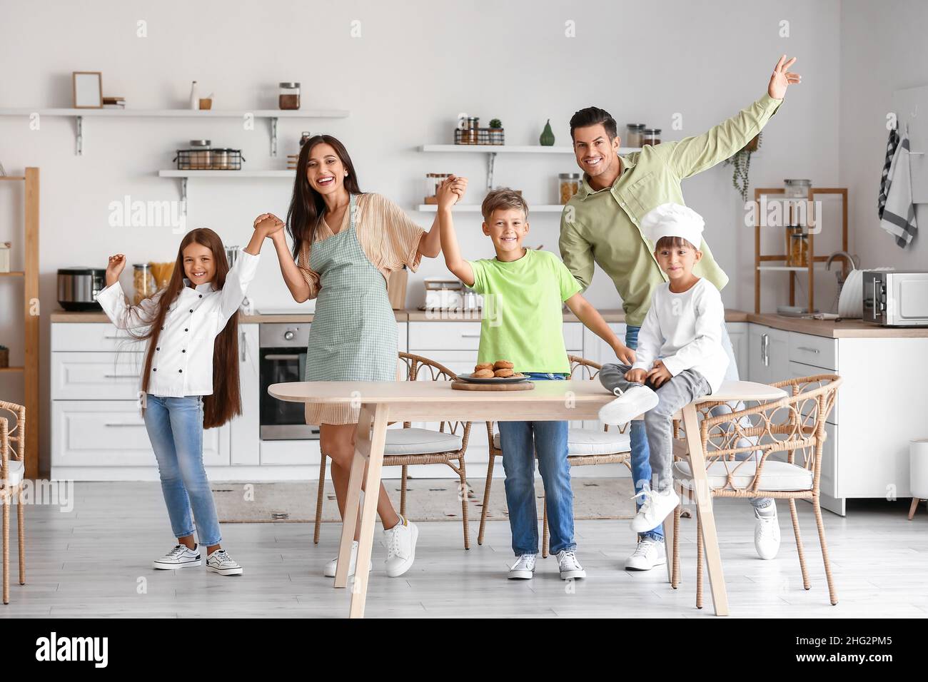 Happy family dancing in kitchen Stock Photo - Alamy