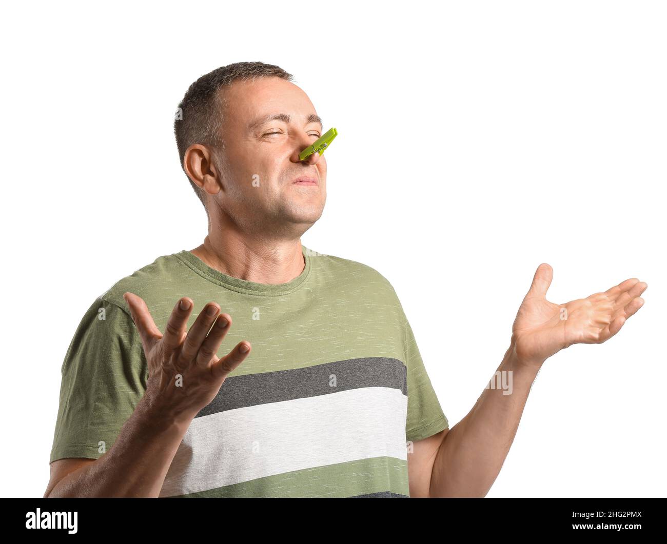 Ill mature man with clothespin on his nose against white background ...