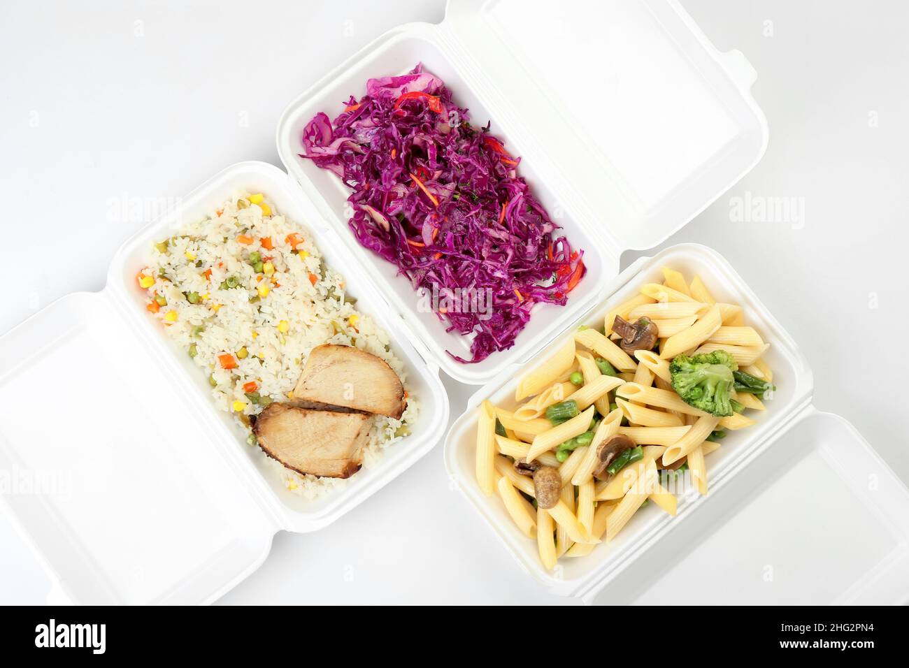 Different tasty food in lunch boxes on light background Stock Photo - Alamy