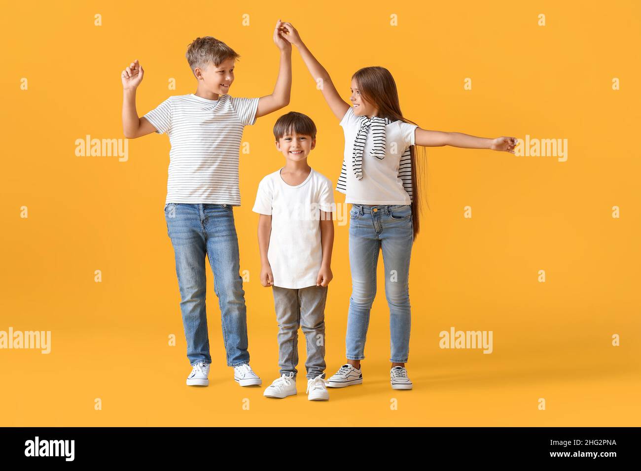 Happy dancing children on color background Stock Photo - Alamy