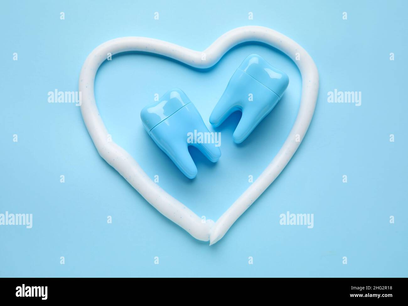 Heart drawn with toothpaste and teeth on blue background Stock Photo ...