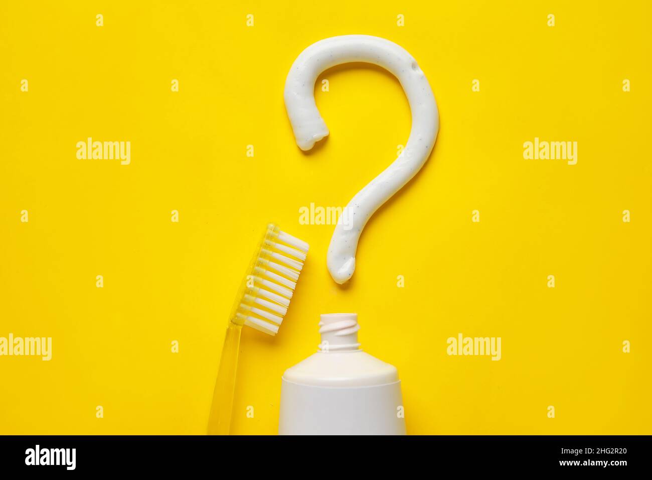 Toothbrush, opened tube and question mark on color background Stock ...