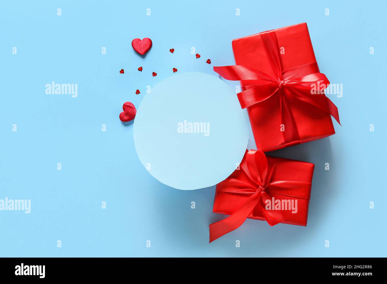 Presents for Valentine day, decorative hearts and blank card on color ...