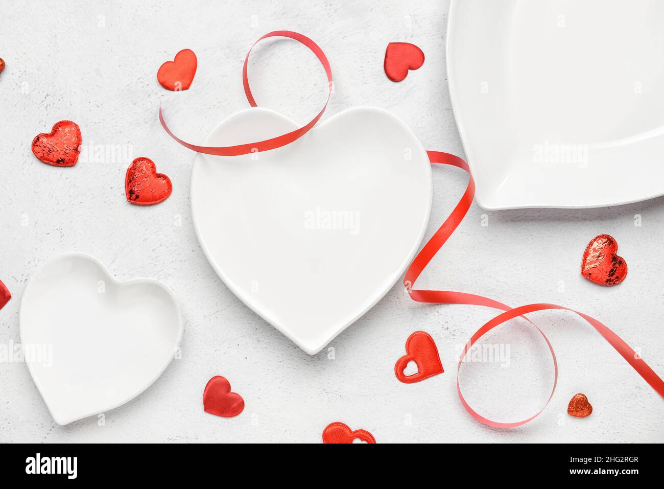 Beautiful heart shaped plates on white background Stock Photo - Alamy