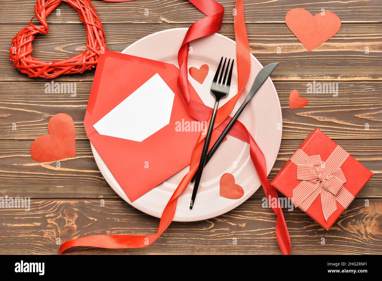 Beautiful table setting for Valentine's Day and envelope on wooden ...