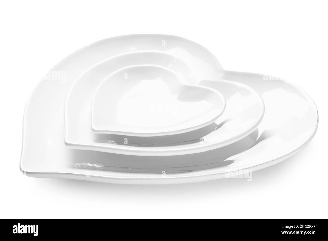 Beautiful heart-shaped plates on white background Stock Photo - Alamy