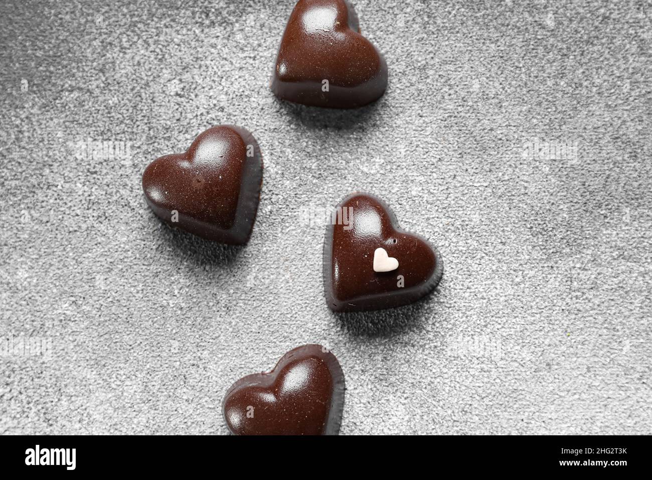 Tasty heart-shaped candies on grey background Stock Photo - Alamy
