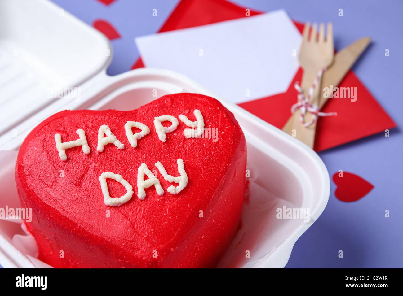 Plastic lunch box with tasty bento cake for Valentine's Day on purple background, closeup Stock ...