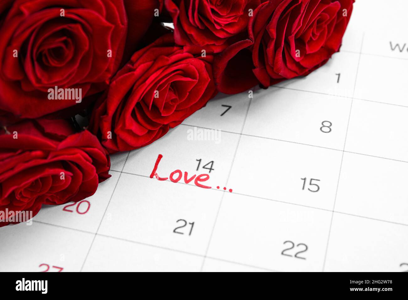 Calendar with word LOVE and roses, closeup. Valentine's Day celebration ...