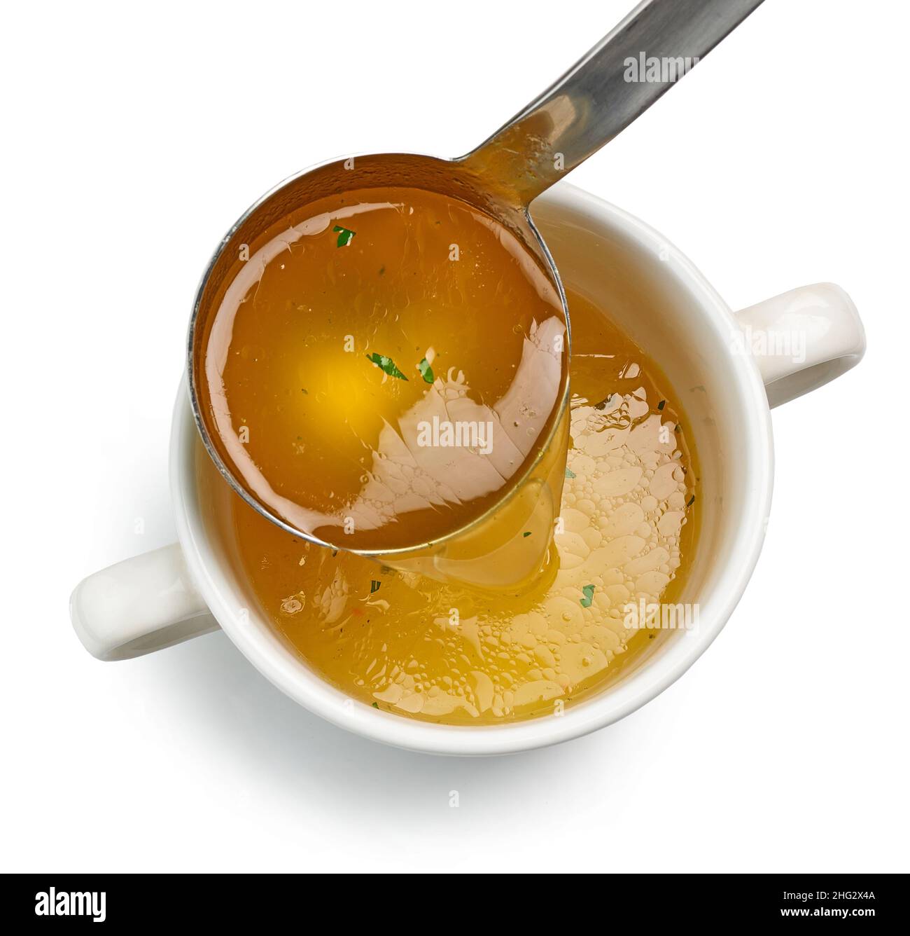 chicken broth pouring into bowl isolated on white background, top view ...