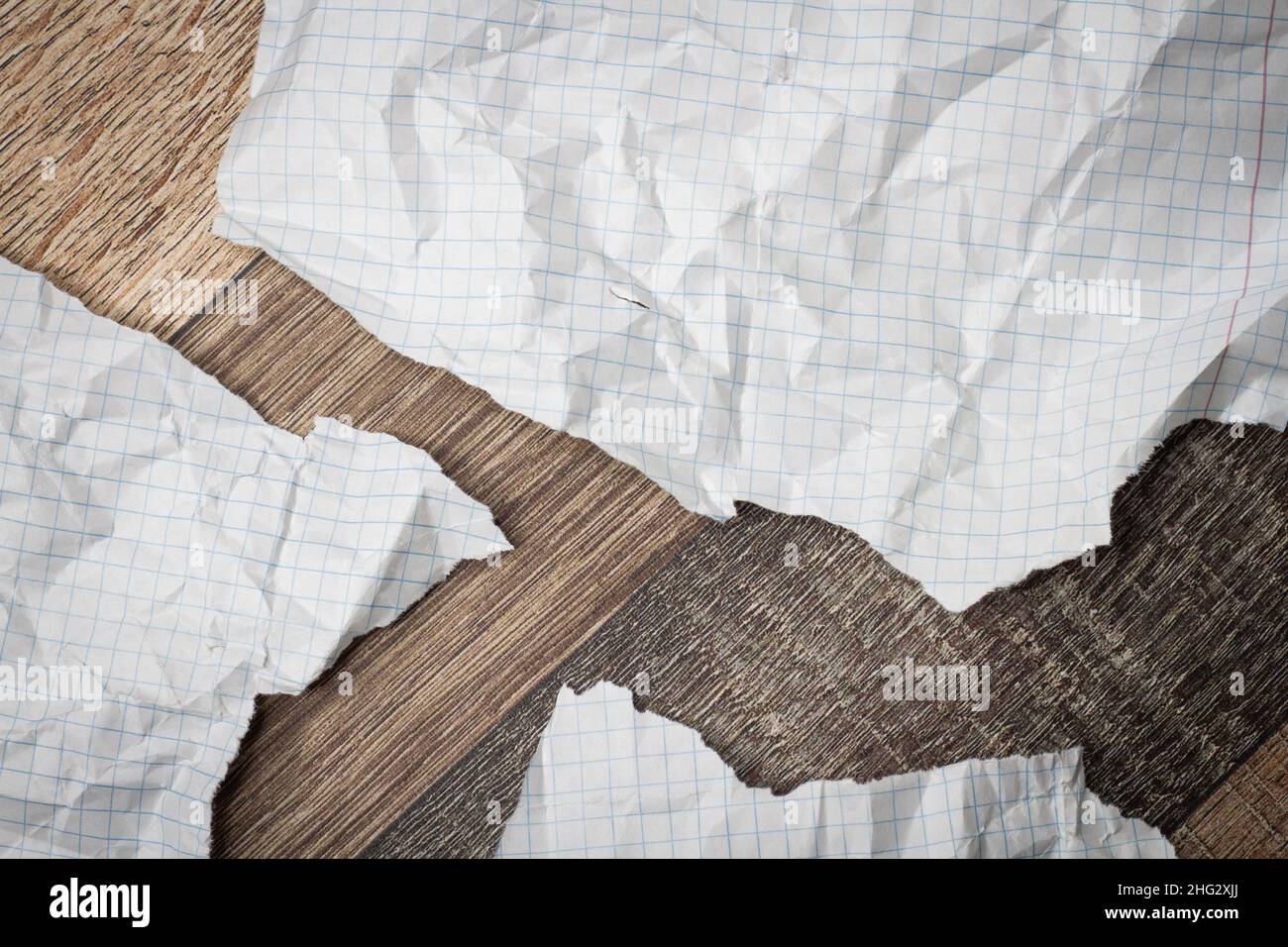 Crumpled and torn paper on the table. Torn piece of notebook. Paper ...