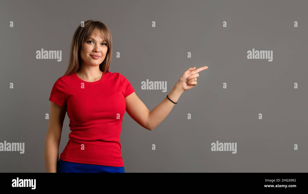 Friendly looking positive young woman giving directions or ...