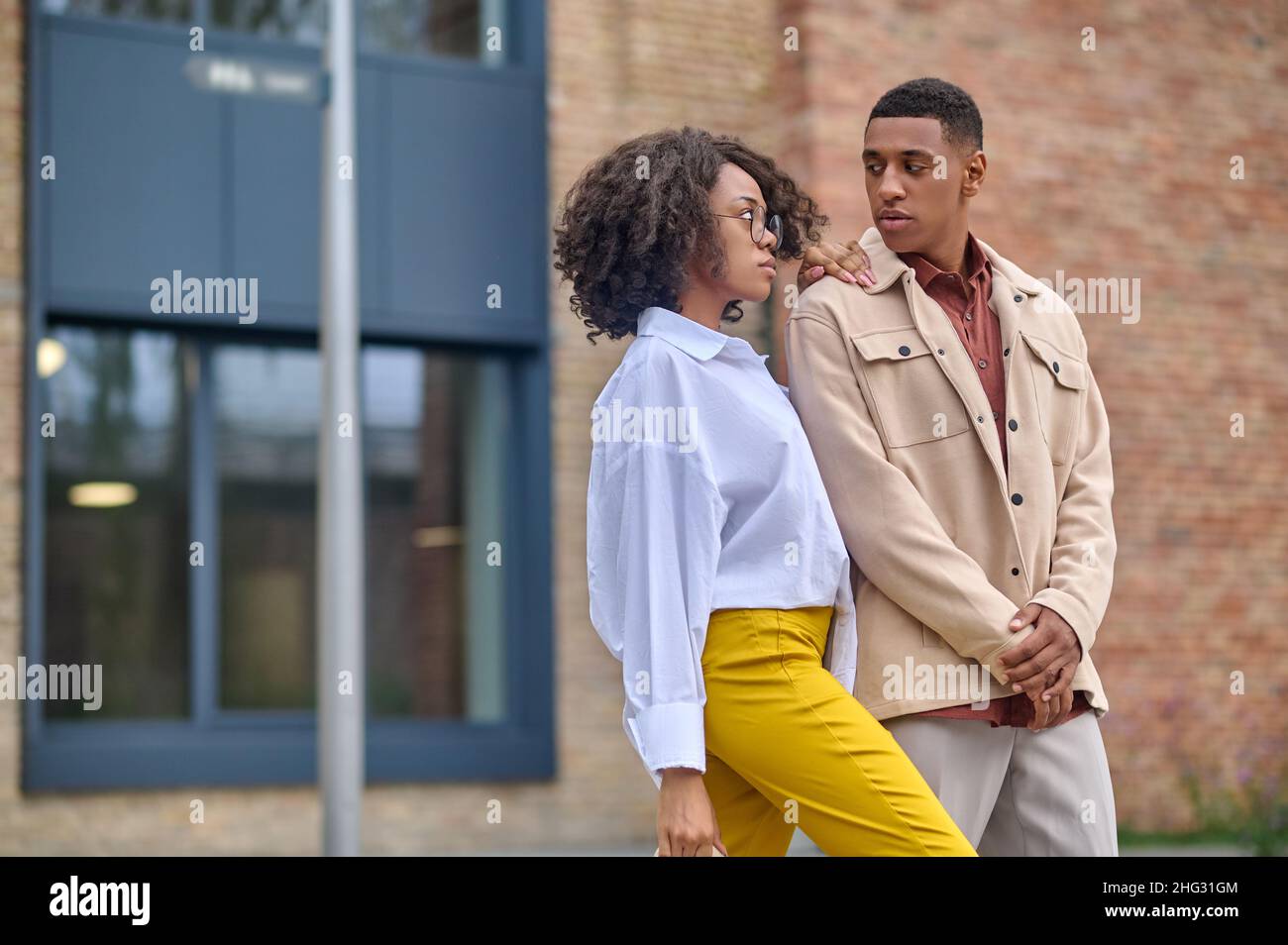Woman sideways to camera touching shoulder of indecisive man Stock ...