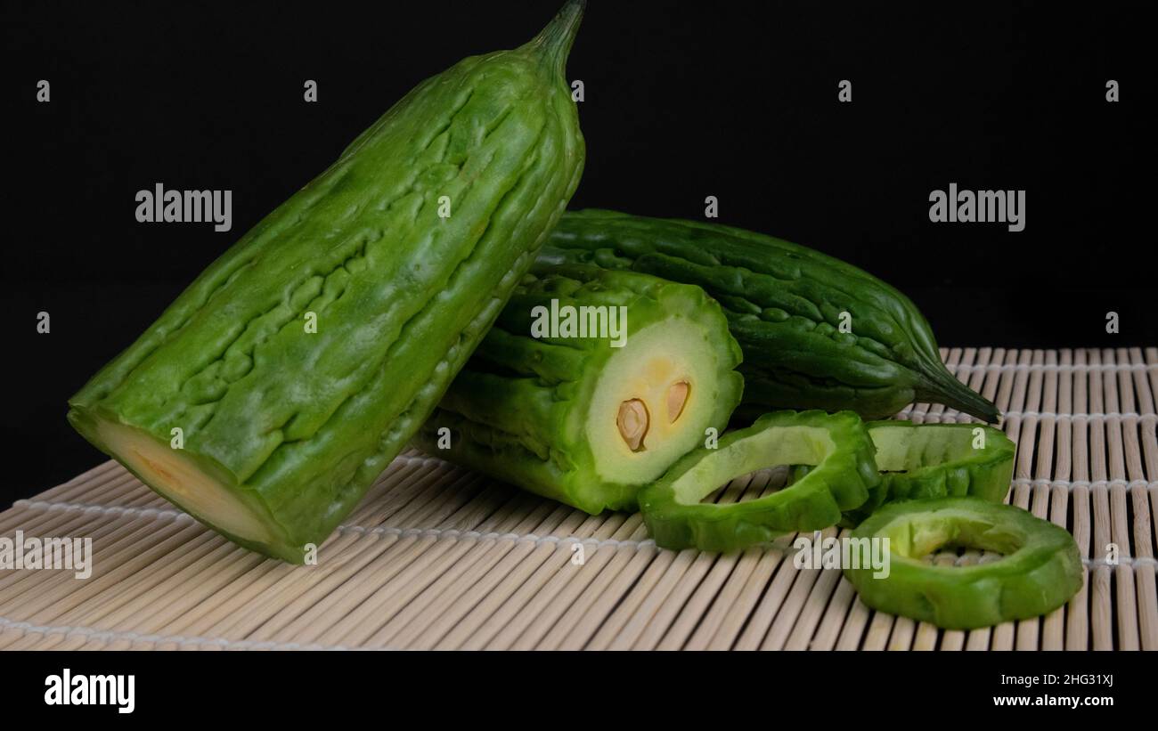 Half Cut Bitter Gourd on a Bamboo Mat Stock Photo - Alamy