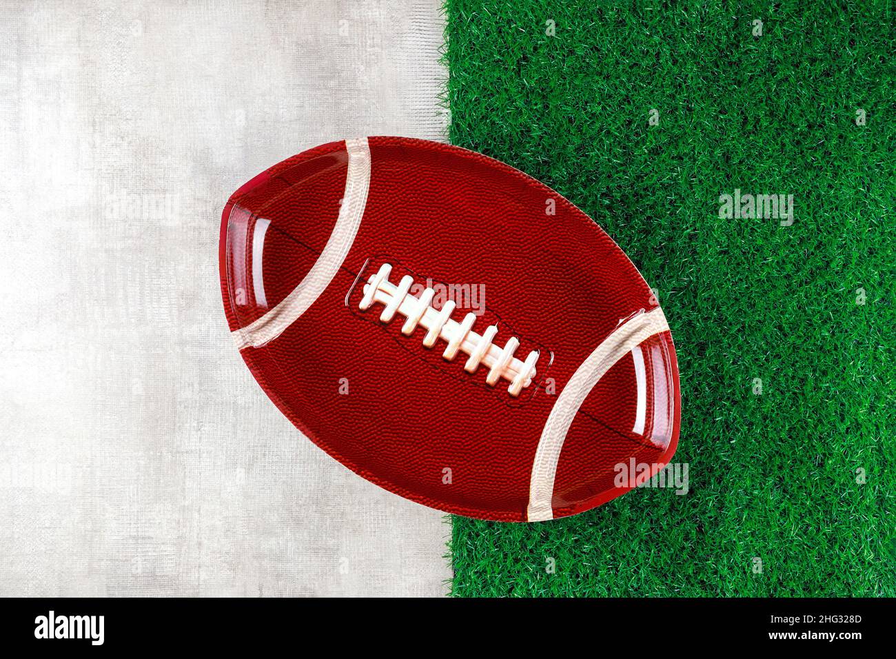 Symbol of american football ball plate on white and green background ...