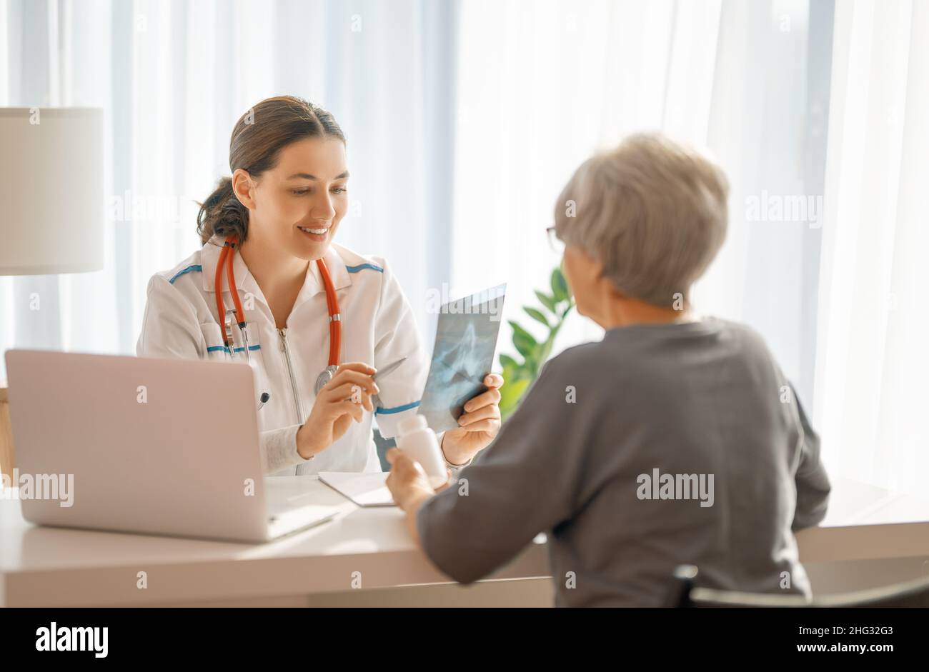 Female patient listening to a doctor in hospital Stock Photo - Alamy