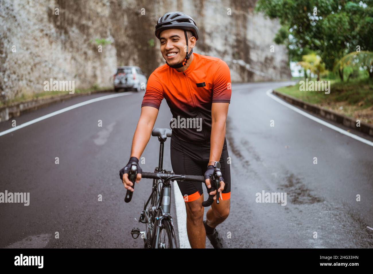 male cyclist pushing his bike and walk after struggling to climb Stock ...
