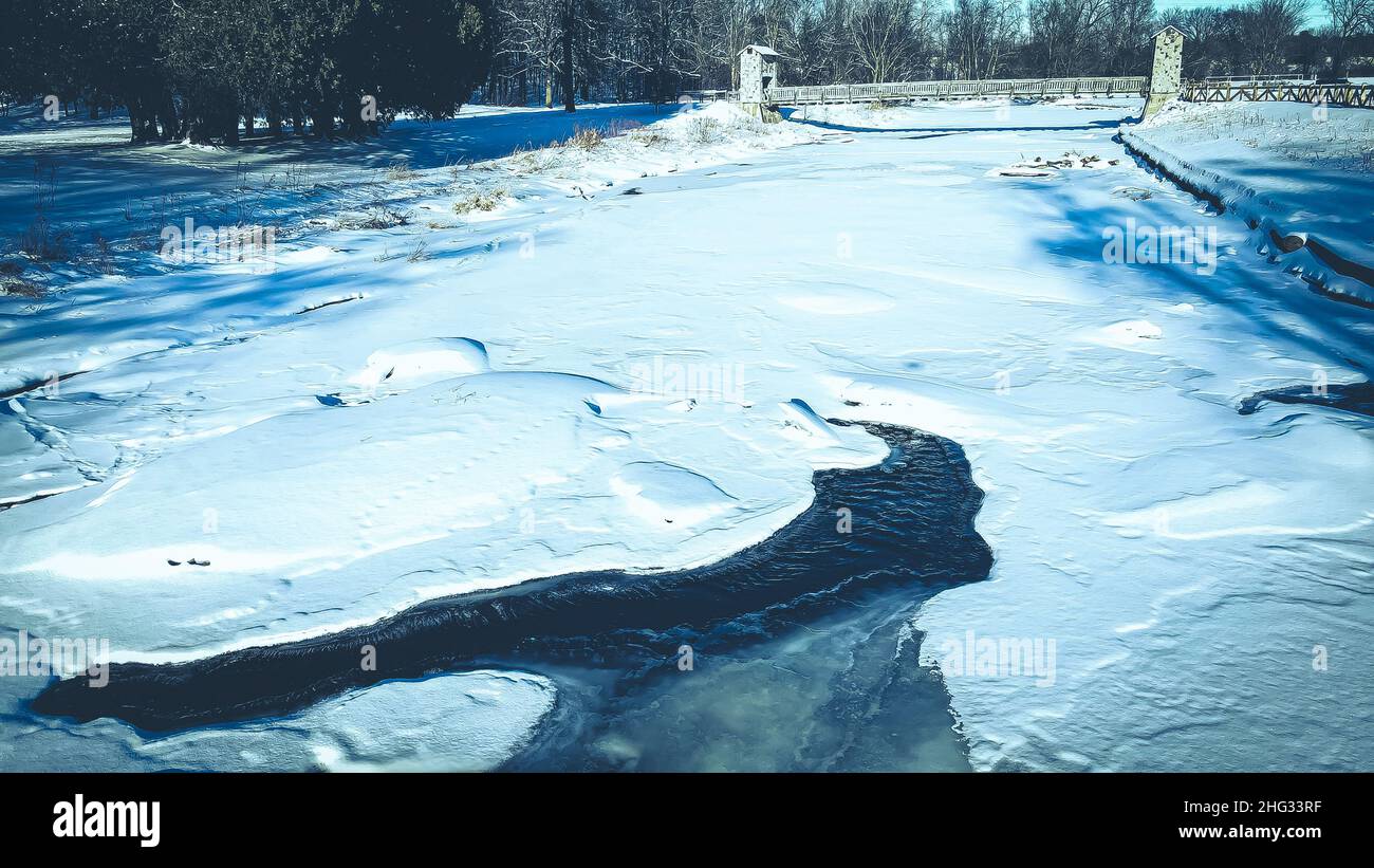 Open water on frozen river Stock Photo - Alamy