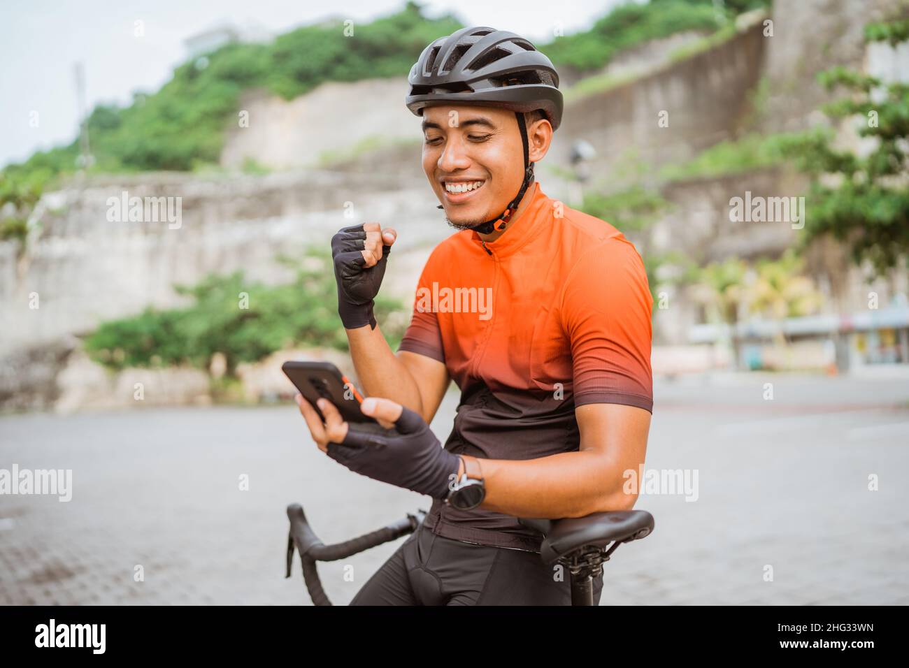 road bike cyclist sitting on his bike while using mobile phone Stock ...