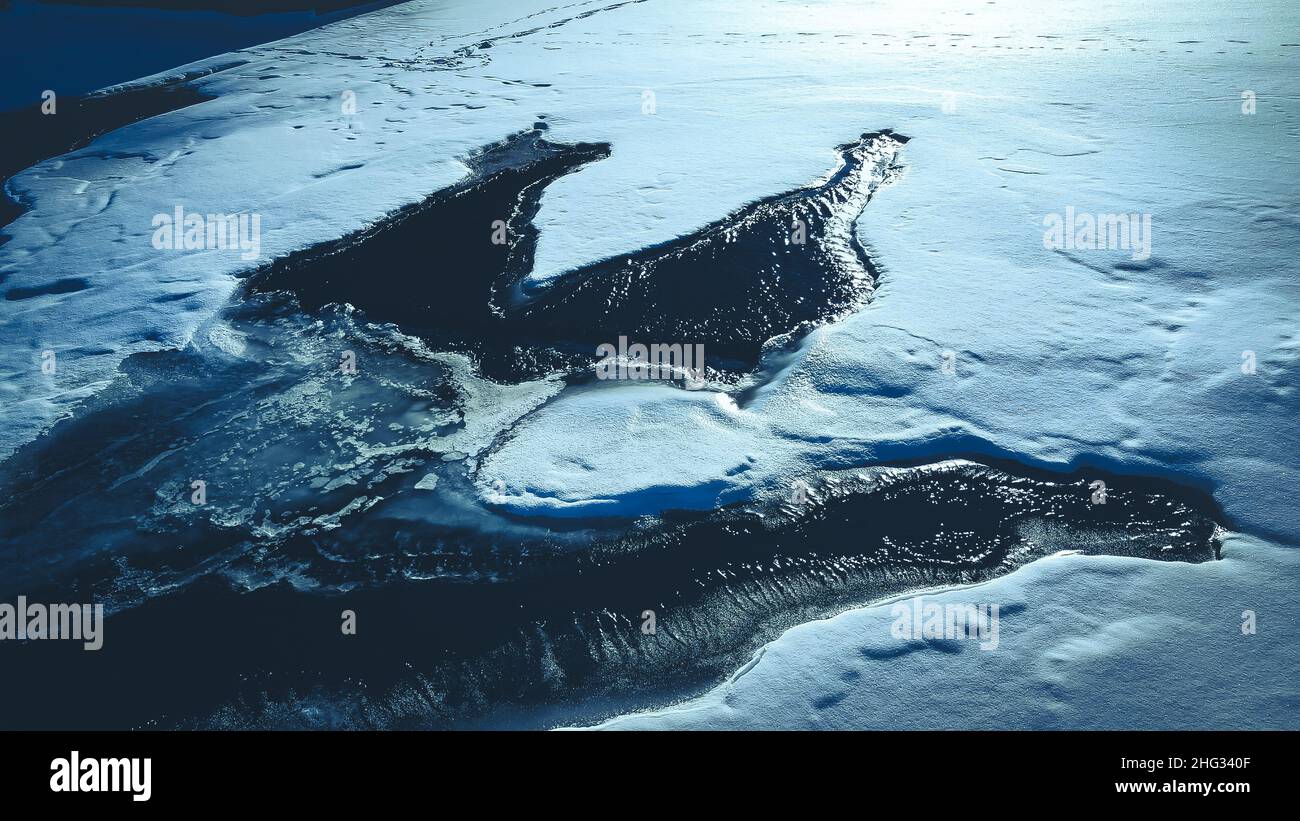 Open water on frozen river Stock Photo - Alamy