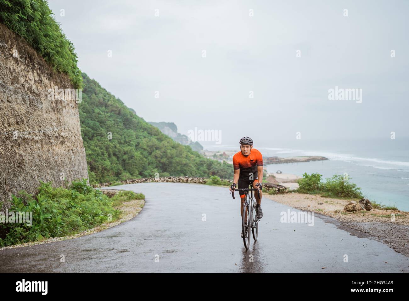 road bike cyclist riding his bike on a cliff Stock Photo - Alamy