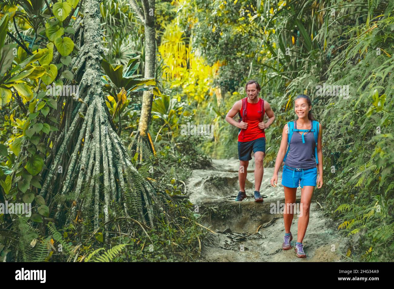Hawaii hiking hikers on Kalalau trail hike walking in rainforest with ...