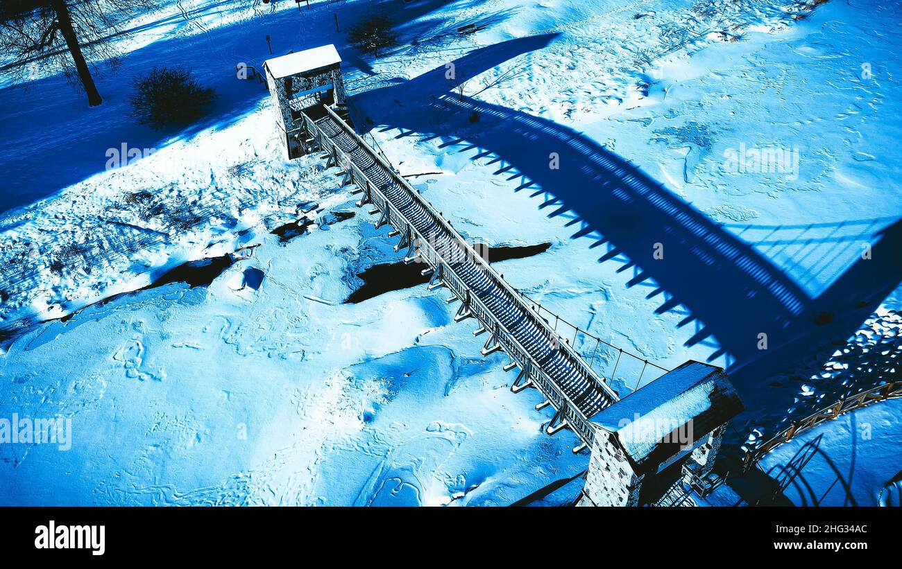 Aerial of frozen bridge over river at park Stock Photo - Alamy