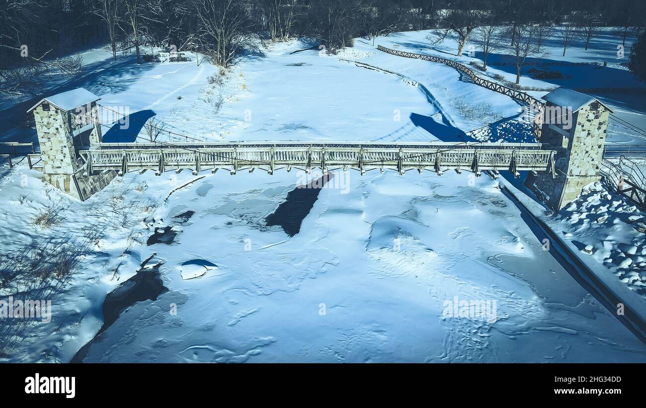 Aerial of frozen bridge over river at park Stock Photo - Alamy