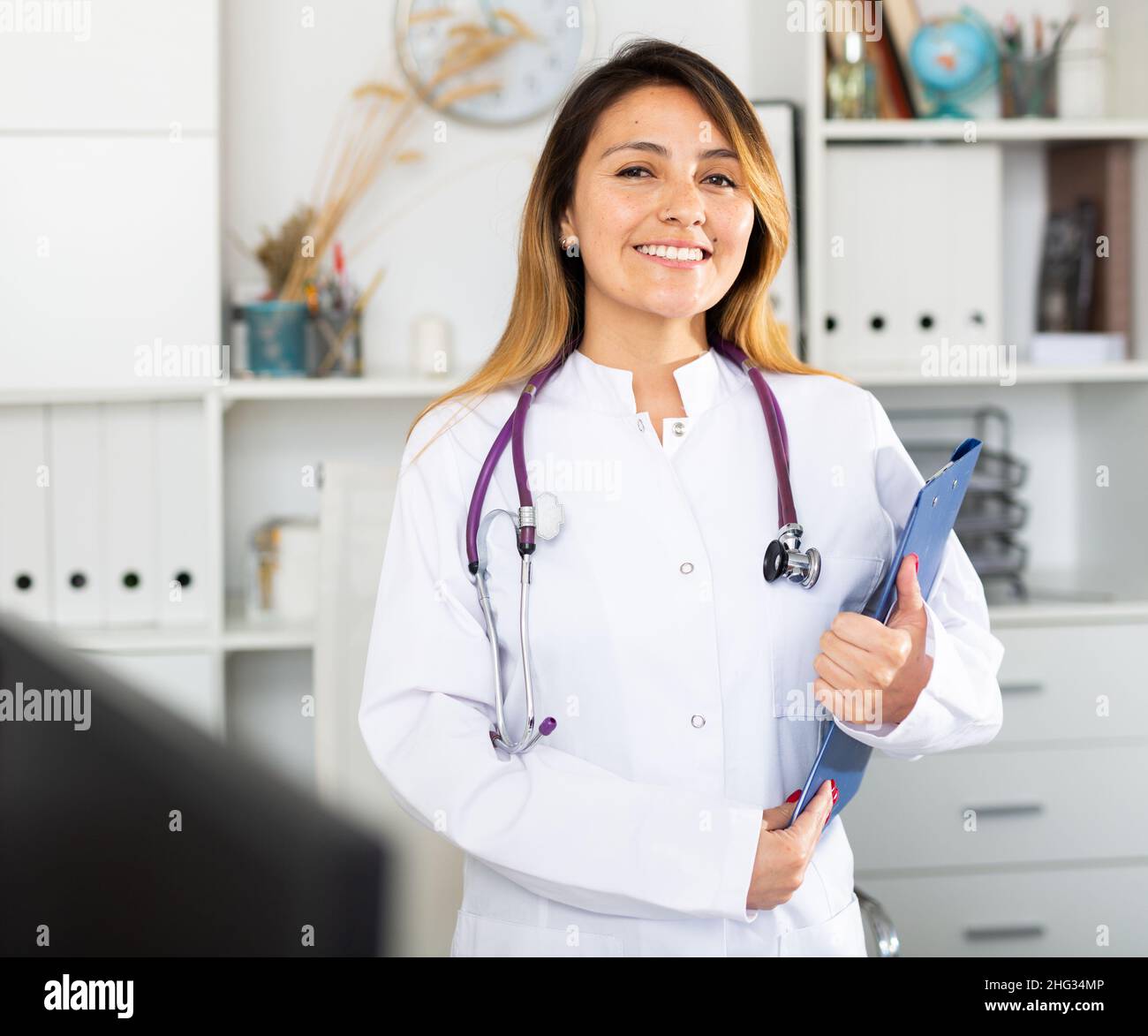 Latina female doctor standing in office Stock Photo - Alamy