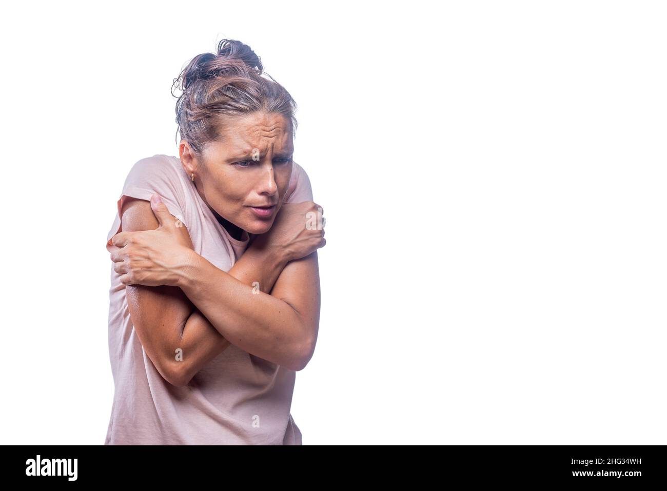 A freezing adult woman on a white background Stock Photo - Alamy