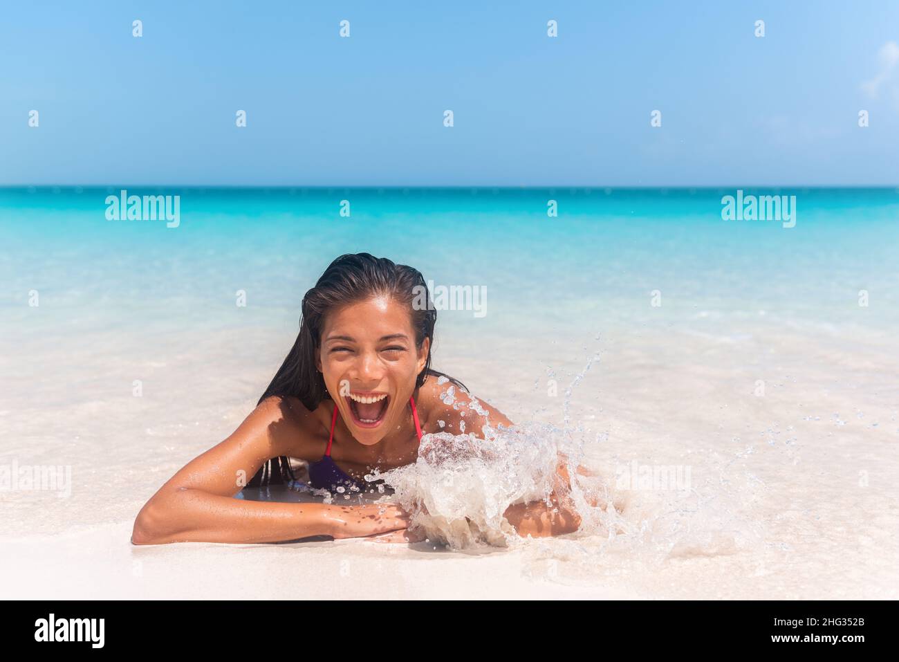 Happy Asian Bikini Woman Laughing Playing In Splashing Wave On