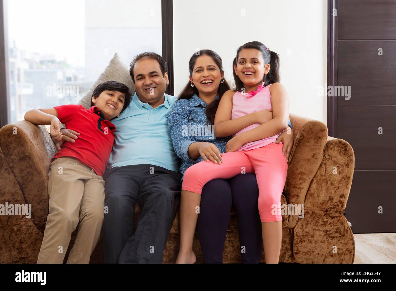 Indian family members sitting in sofa together with smile Stock Photo ...