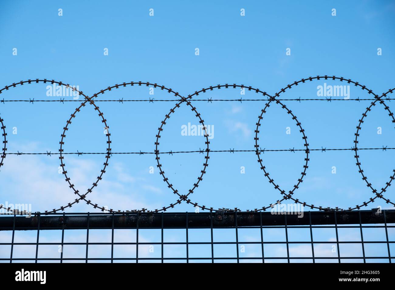 Round barbed wire fence against blue sky with copy space Stock Photo ...