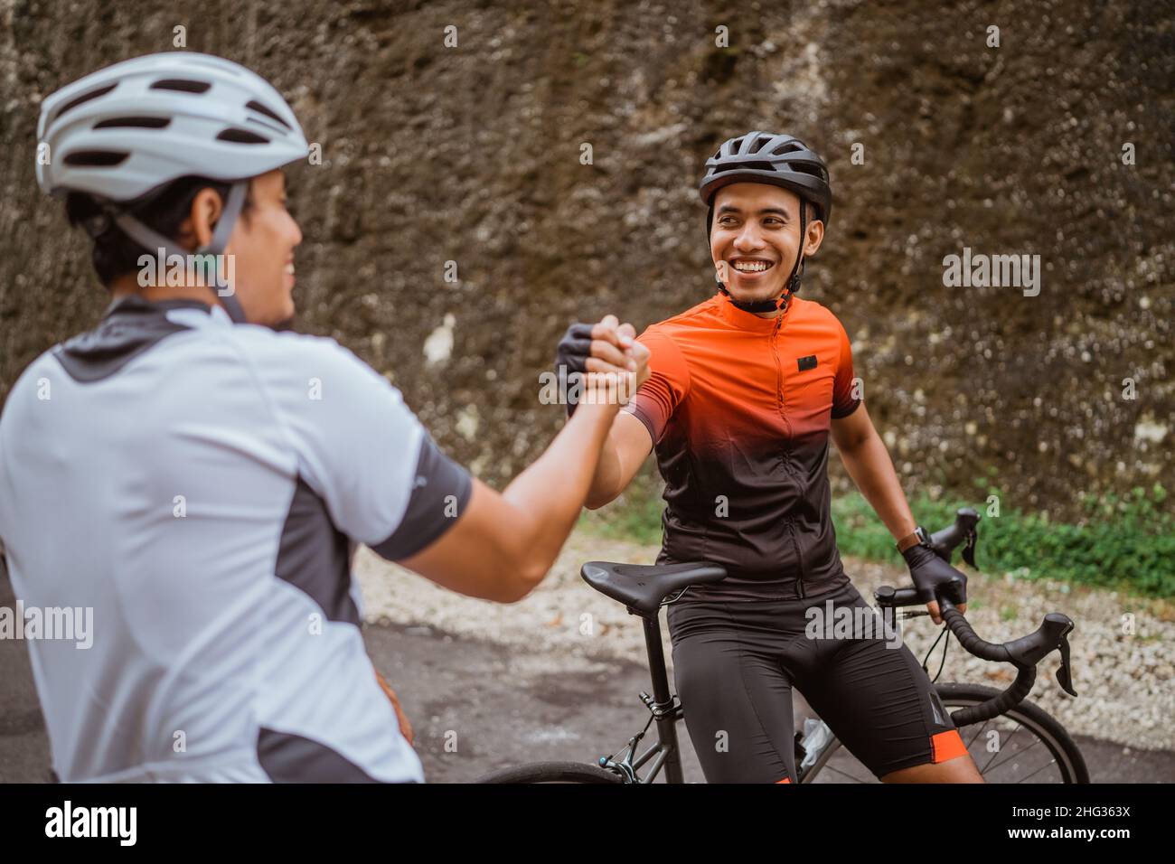 two cyclist friend high five when finish his race together Stock Photo ...