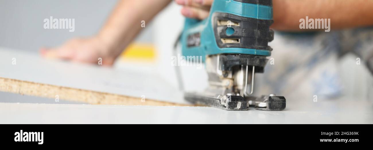 Man using tool for work Stock Photo - Alamy