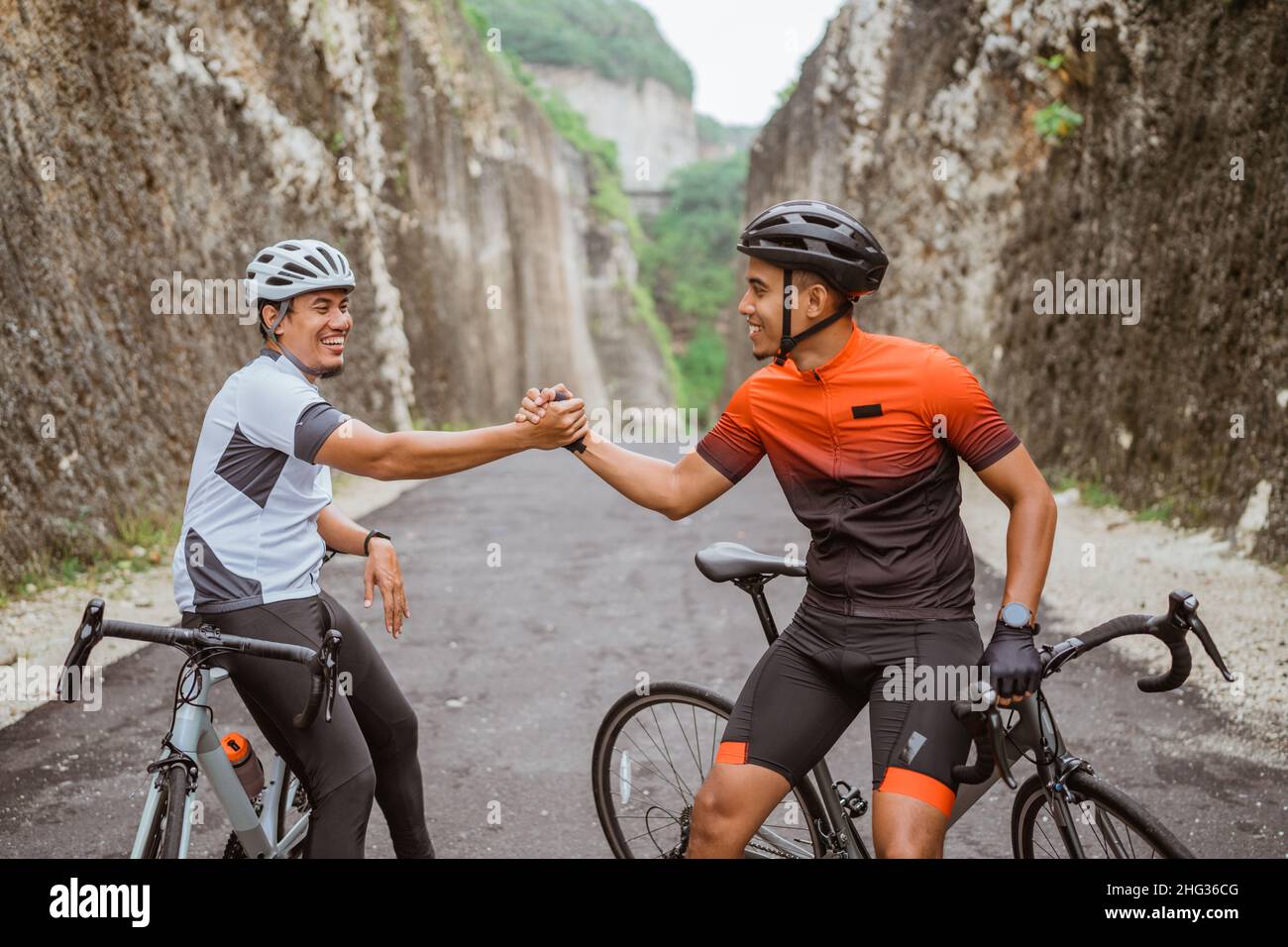two cyclist friend high five when finish his race together Stock Photo ...