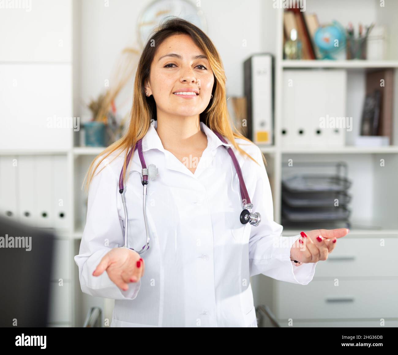 Mexican female medic in uniform standing in doctor's office Stock Photo ...