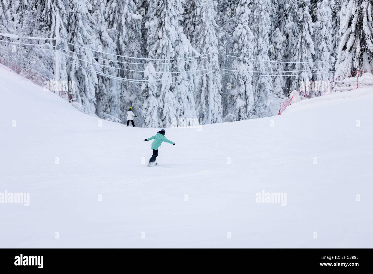 Young girl snowboarder snowboarding down the slope in Finland Stock ...