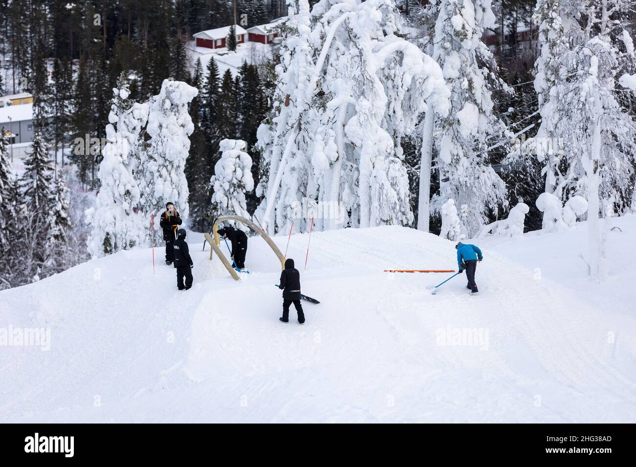 Vuokatti, Finland - January2022: Young men working and shoveling snow ...