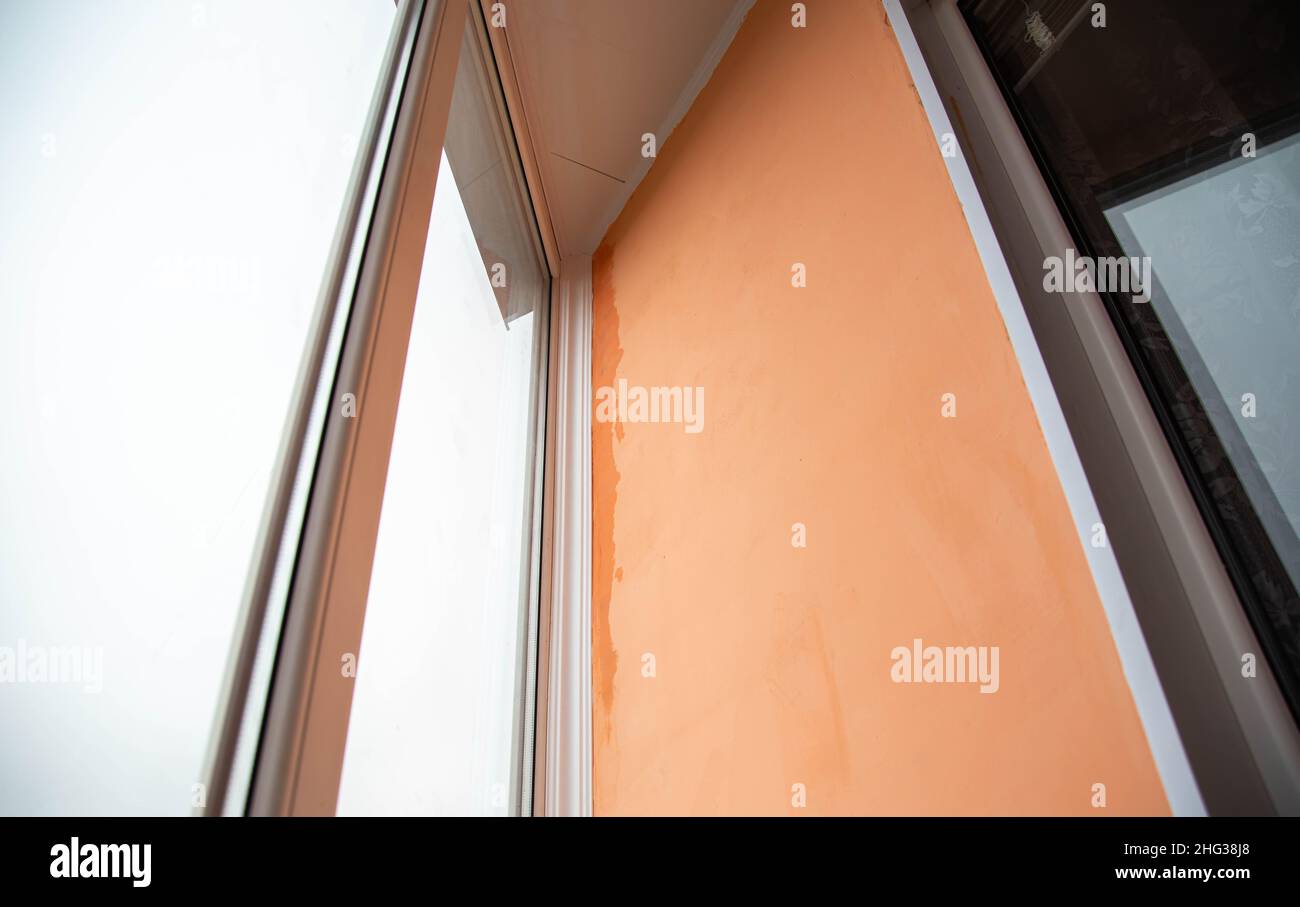 Rain dripping in the corner on the balcony between the window frame and ...