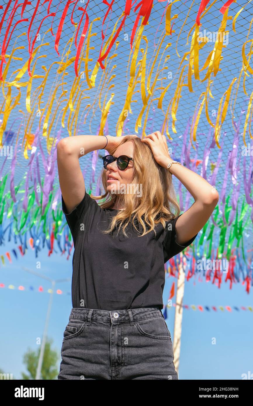 Young woman sitting on festival. Gen z girl enjoying outdoors ...