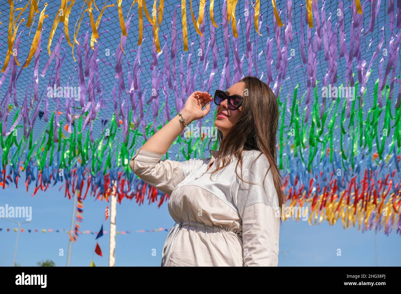 Young woman sitting on festival. Gen z girl enjoying outdoors ...