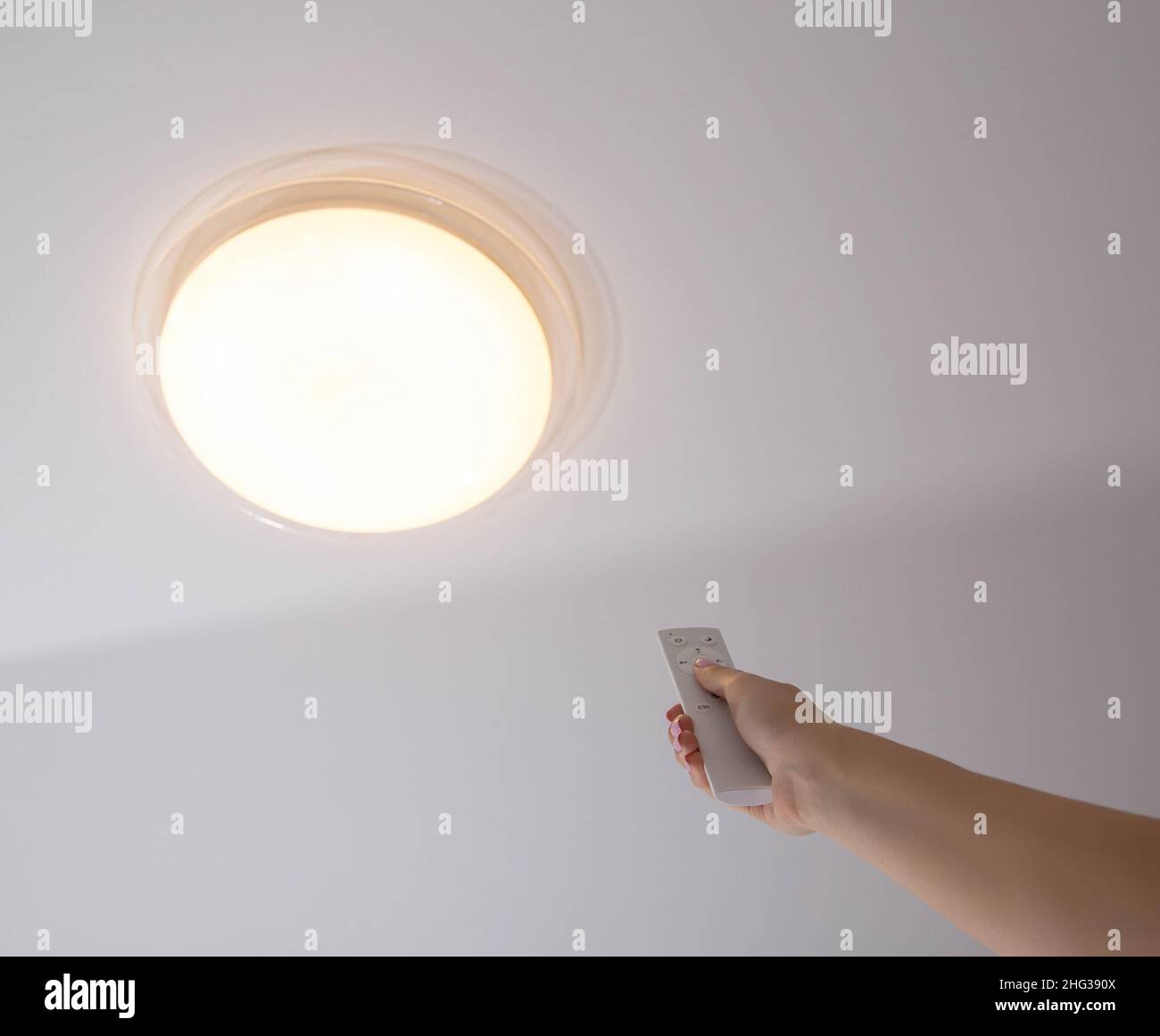 Modern LED ceiling chandelier with on off control panel. Adjusting the ...