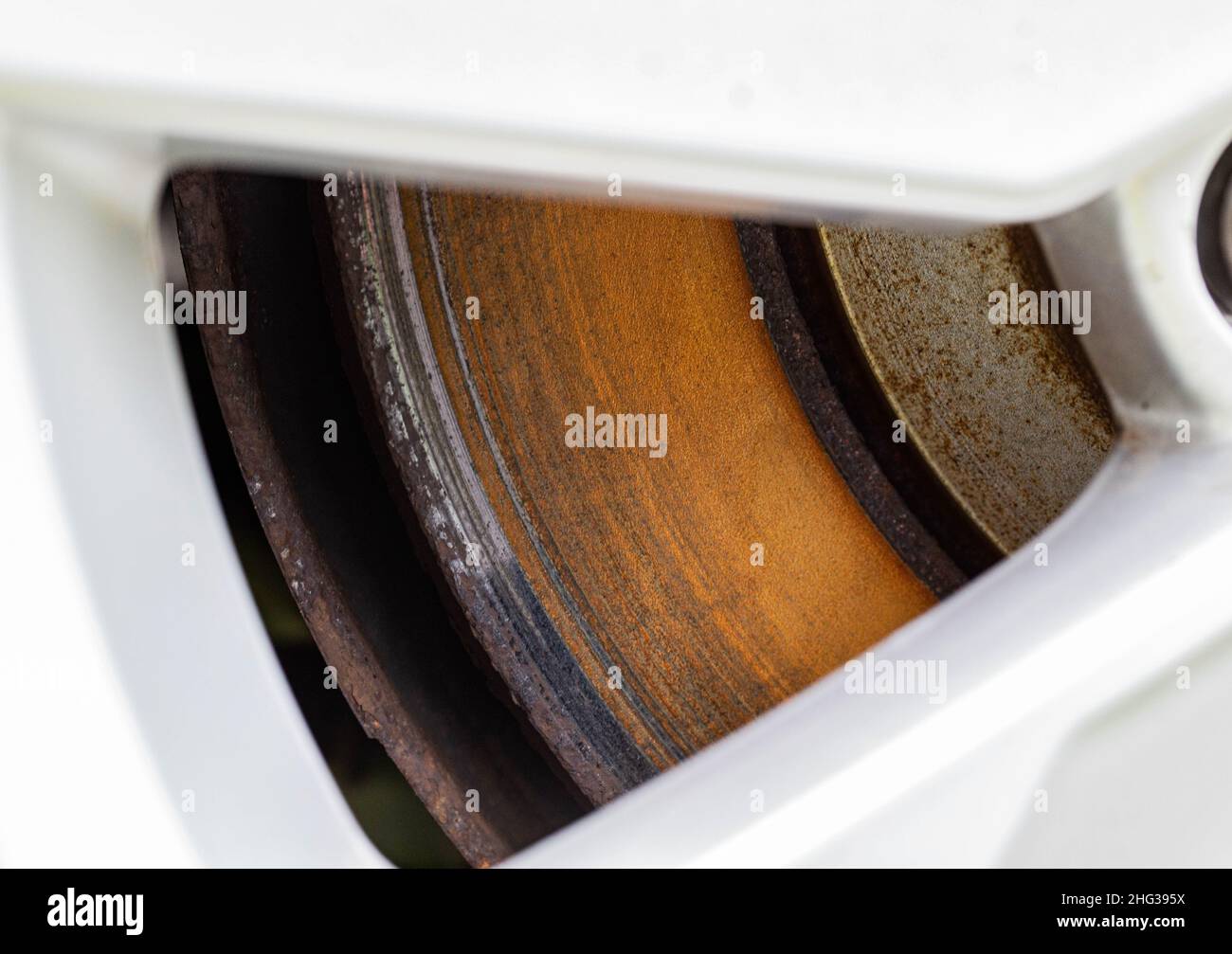 Rusty, defective brake disc with a shoulder on the edge. Worn brake ...