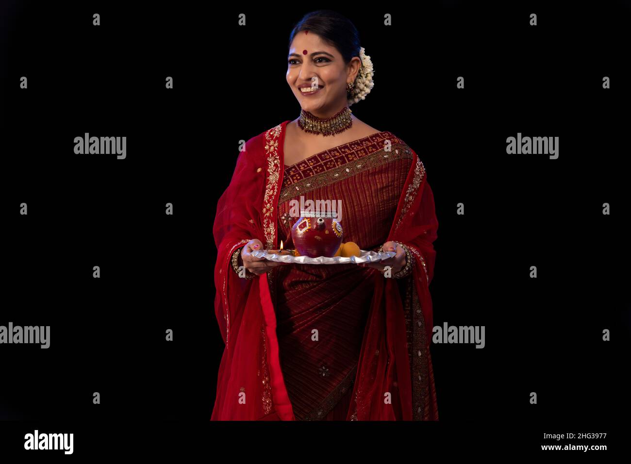 An Indian woman performing ritual on the occasion of Karva Chauth Stock ...