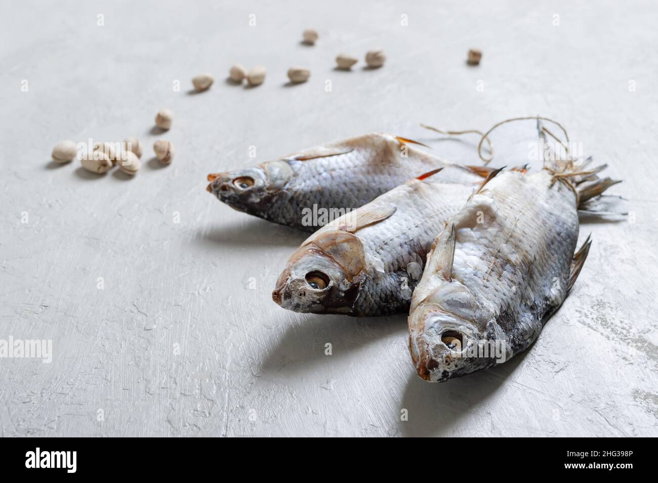 Salted or air-dried carp on a light concrete background. Traditional ...